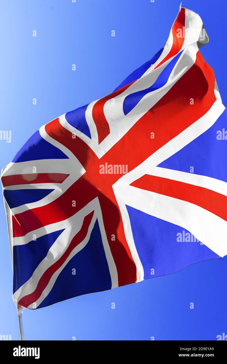Flag of Great Britain waving against blue sky Stock Photo - Alamy