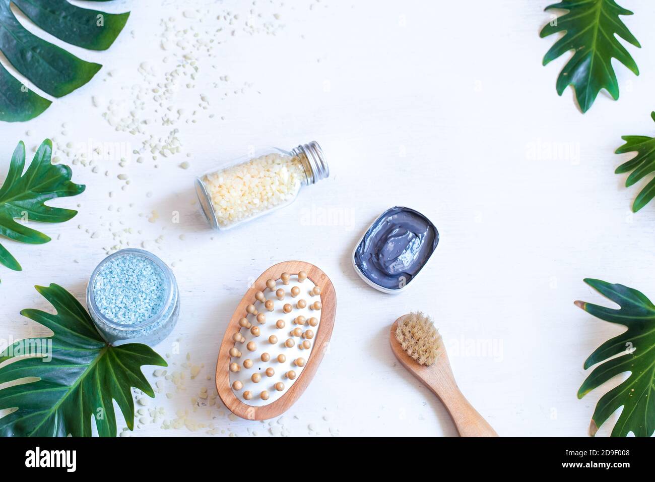 Spa composition with body care items and natural leaves on a white ...