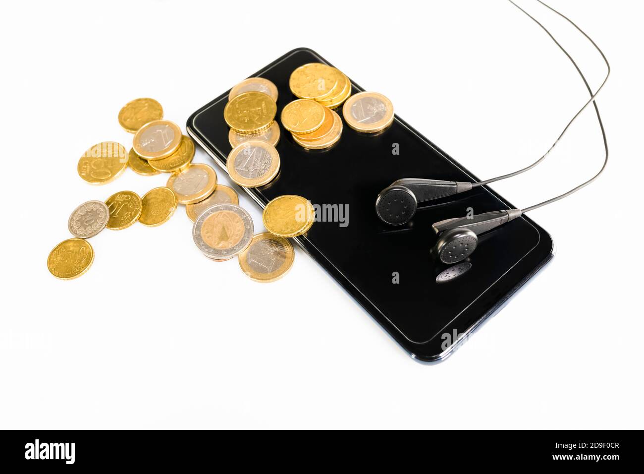 top view of a phone and coins with headphones isolated on a white ...