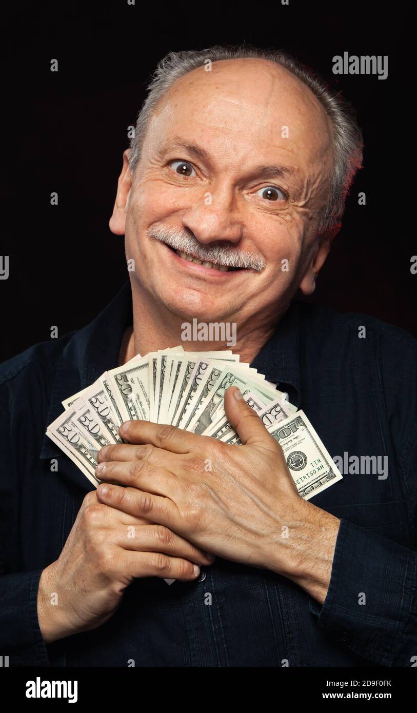Senior Gentleman Holding A Stack Of Money Portrait Of An Excited Old