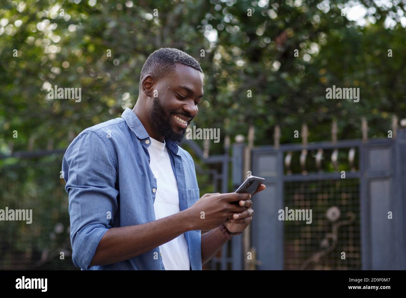 Happy man using mobile phone apps, texting message, browsing internet ...
