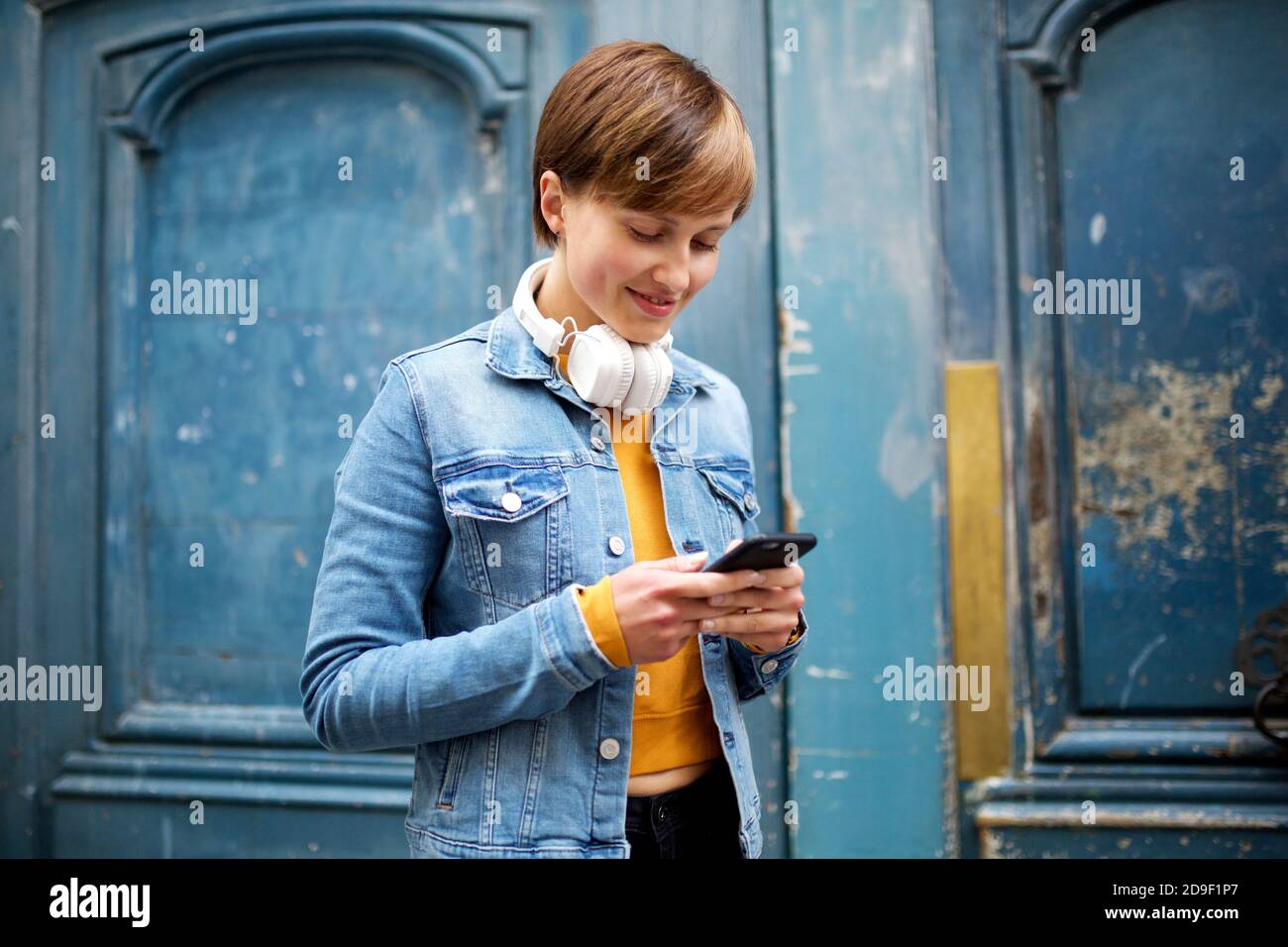 Portrait cool young woman sending text message with mobile phone Stock ...