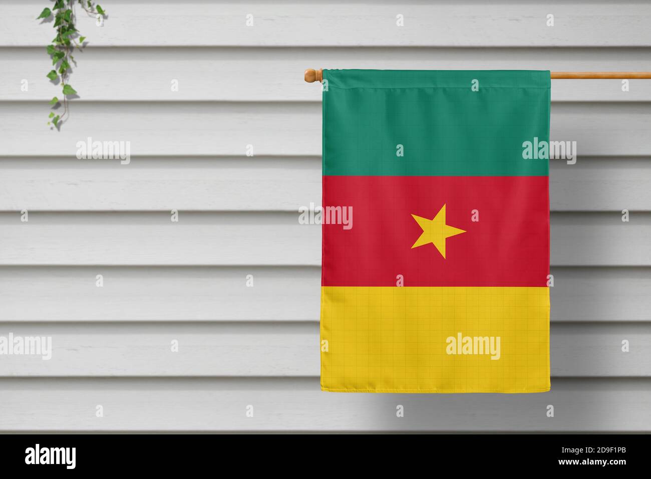 Cameroon national small flag hangs from a picket fence along the wooden ...