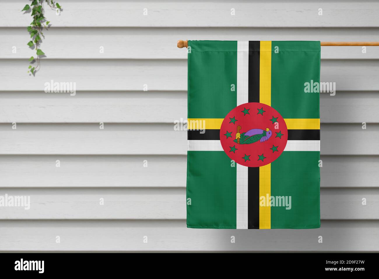 Dominica national small flag hangs from a picket fence along the wooden ...