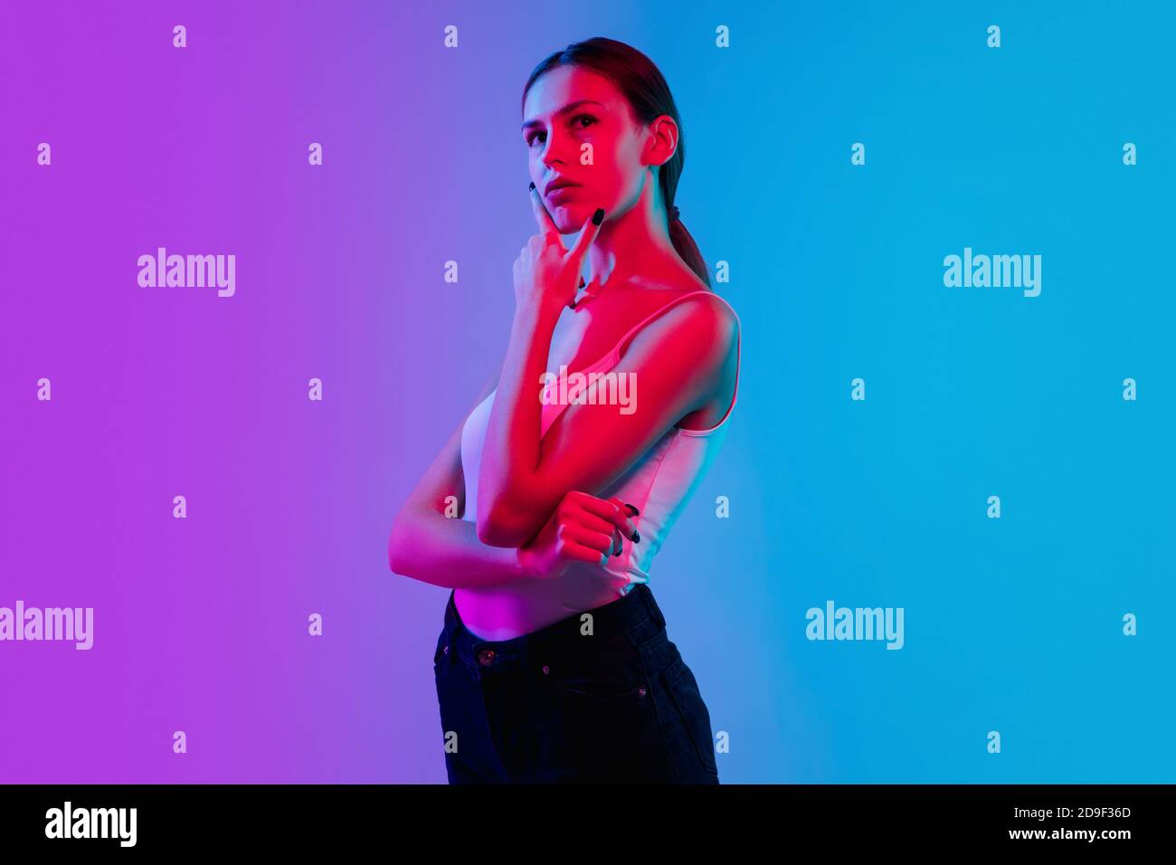 Thoughtful, dreamful. Young caucasian woman's portrait on gradient blue ...