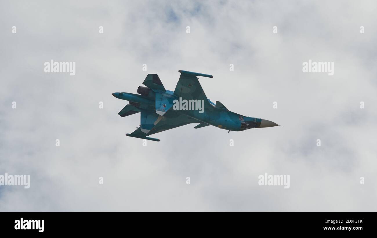 Fighter Su-34 in the sky over the airfield upside down.Aviation show at ...