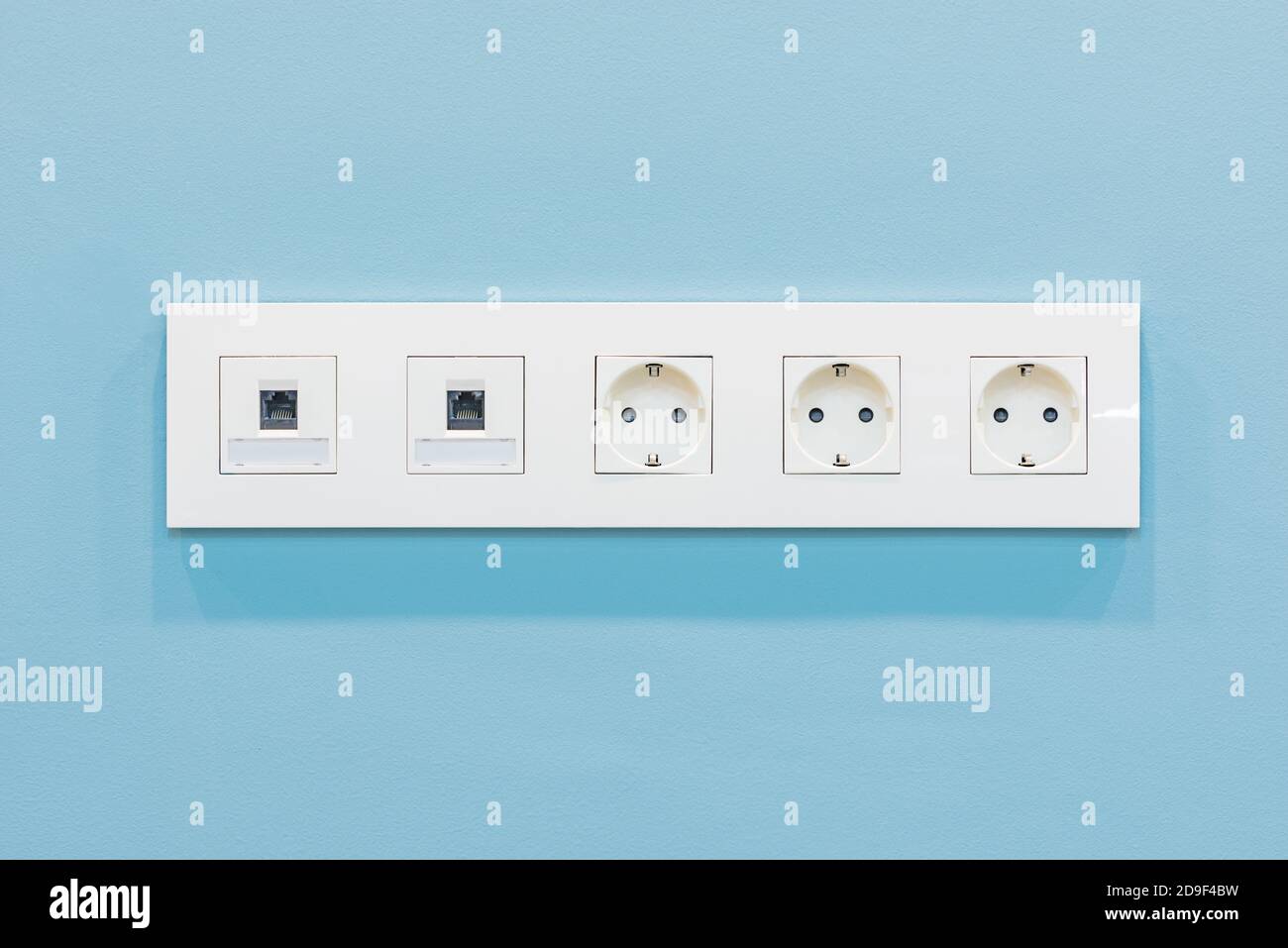 Power socket and Internet socket on blue wall background Stock Photo ...