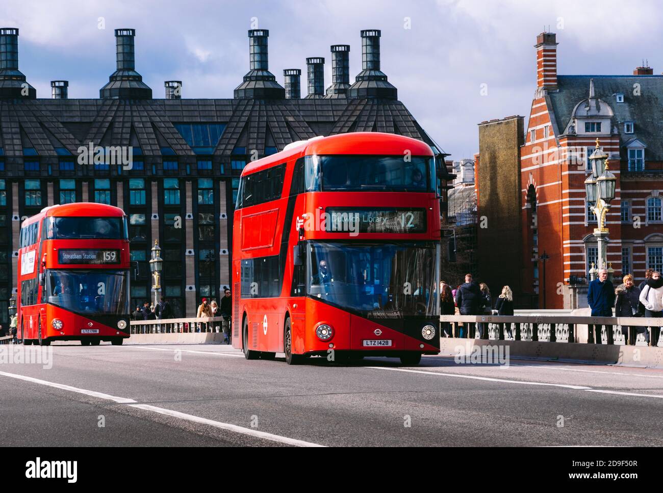 Two red buses crossing the Westminser Bridge in London,UK Stock Photo ...