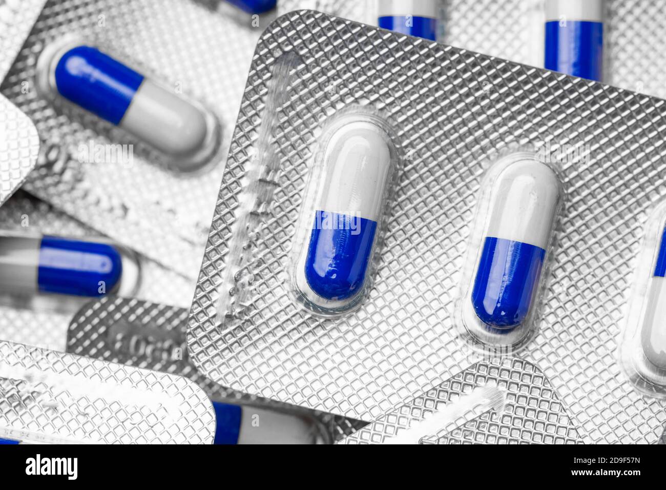 Blue and white capsule pills in blister packs Stock Photo - Alamy