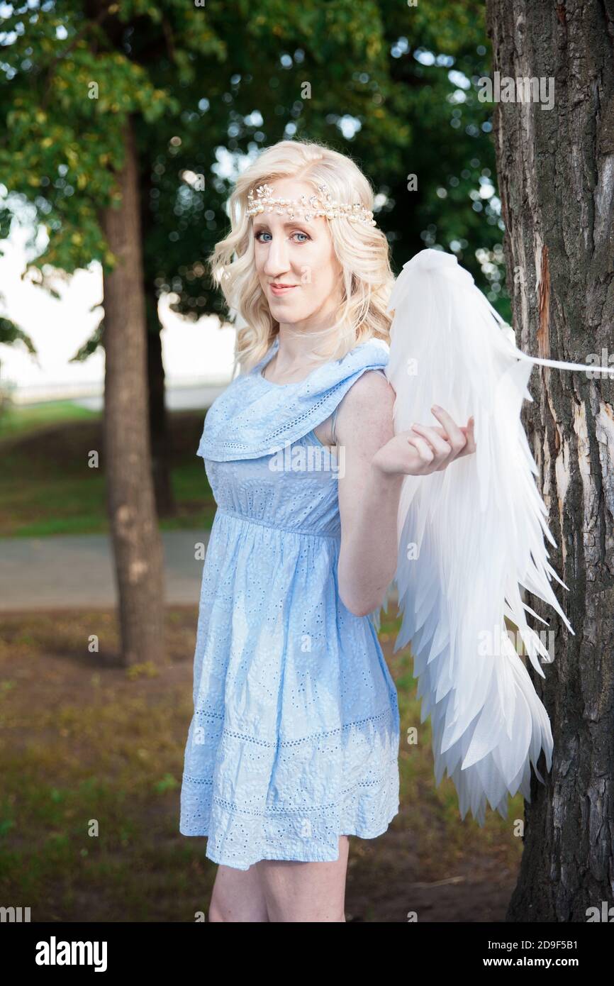 Angel girl with large white feather wings Stock Photo - Alamy