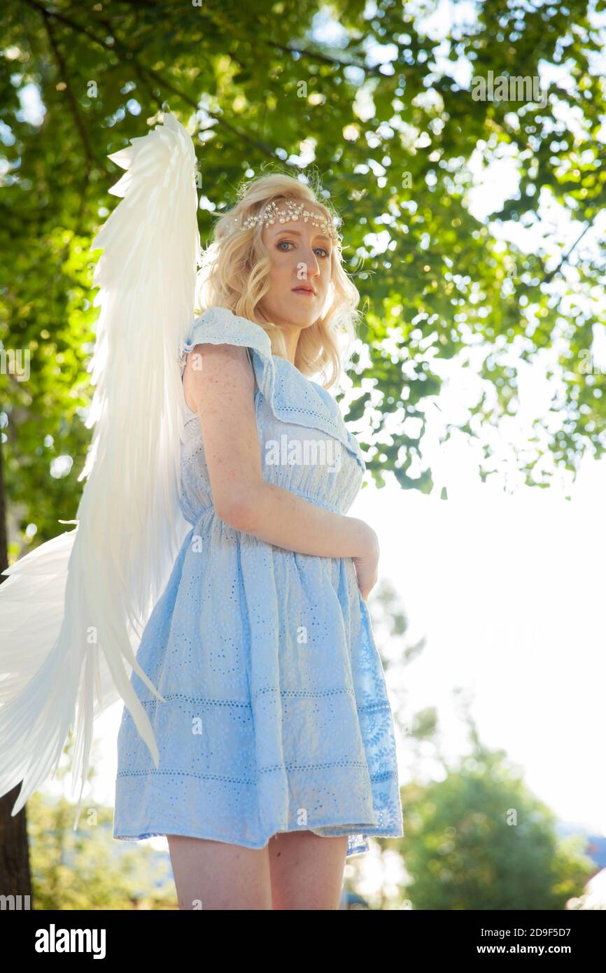 Angel girl with large white feather wings Stock Photo - Alamy