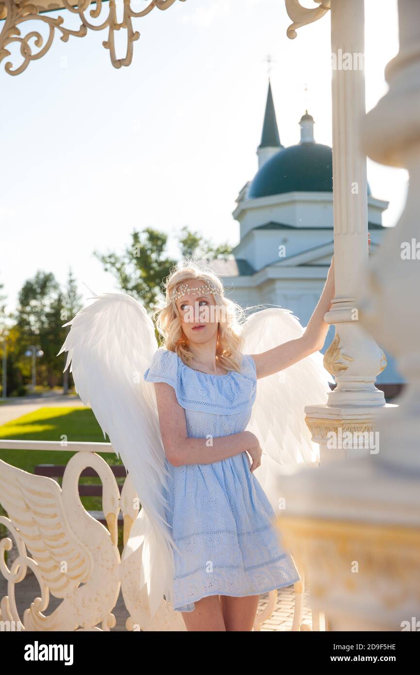 Angel girl with large white feather wings Stock Photo - Alamy