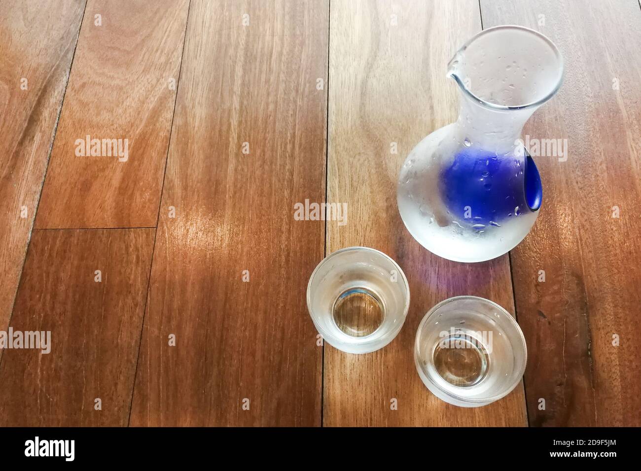 Refreshing cold Japanese sake on wooden platform Stock Photo - Alamy