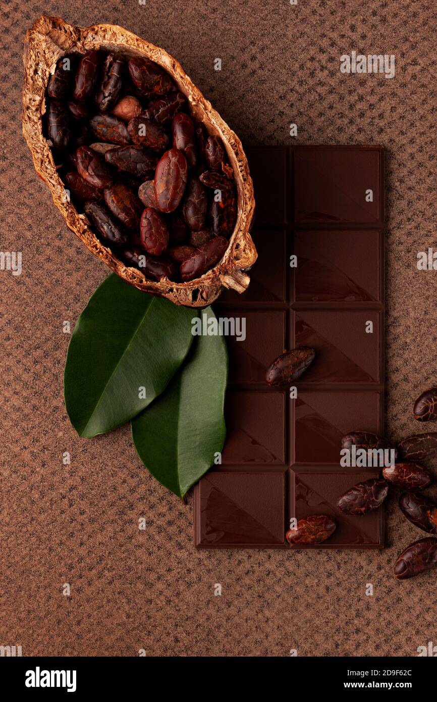 Delicious dark chocolate background. Chocolate bar, cocoa beans and ...
