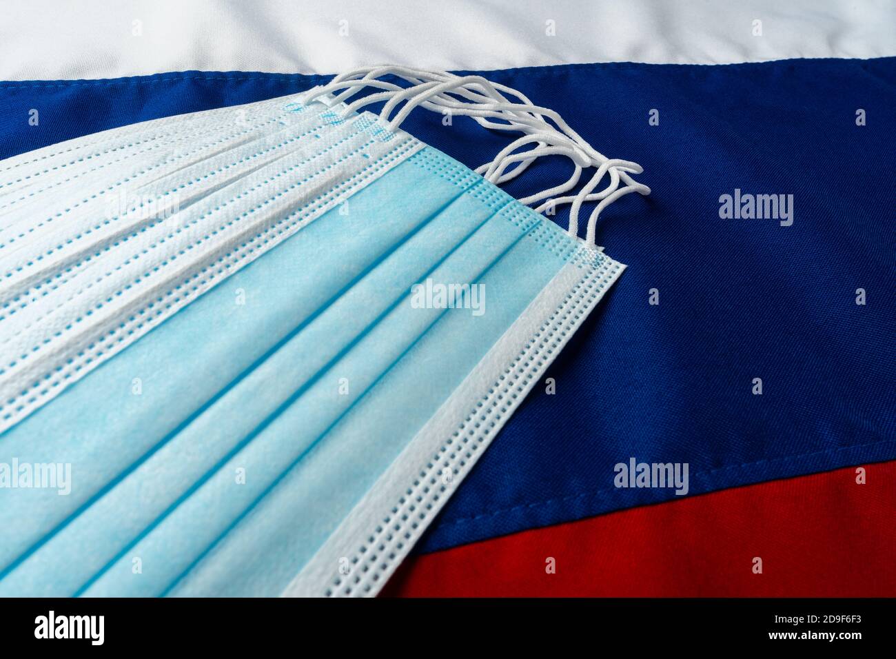 Medical face masks on flag of Russia Stock Photo - Alamy