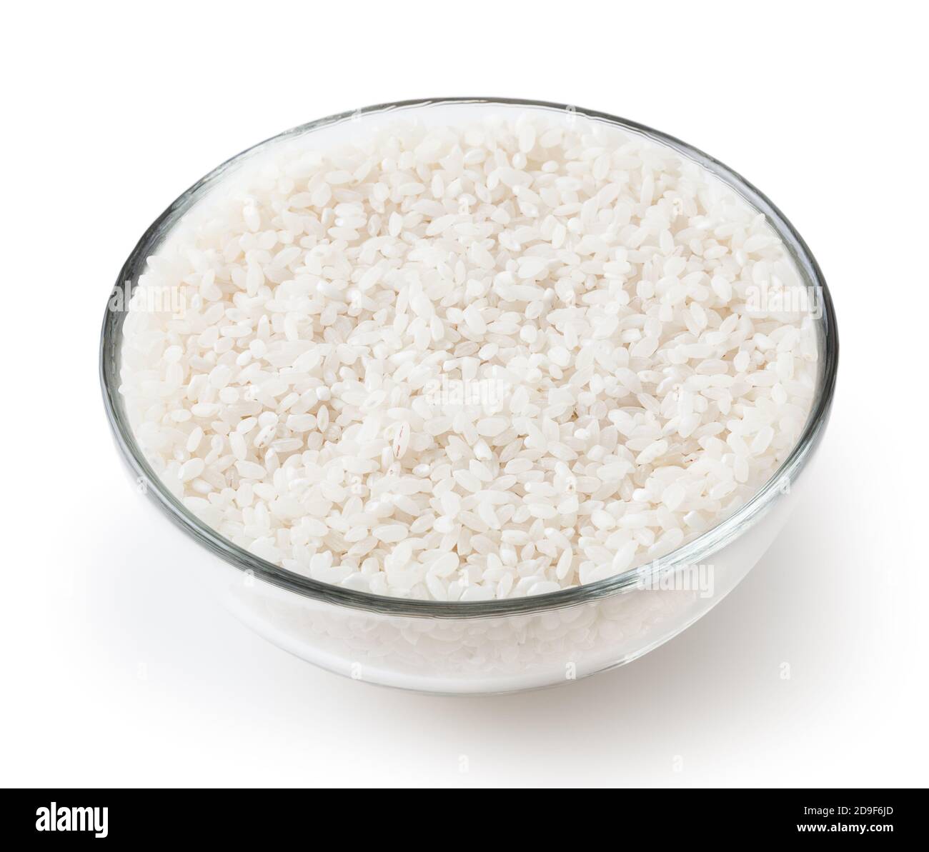 Uncooked round rice in glass bowl isolated on white background with ...