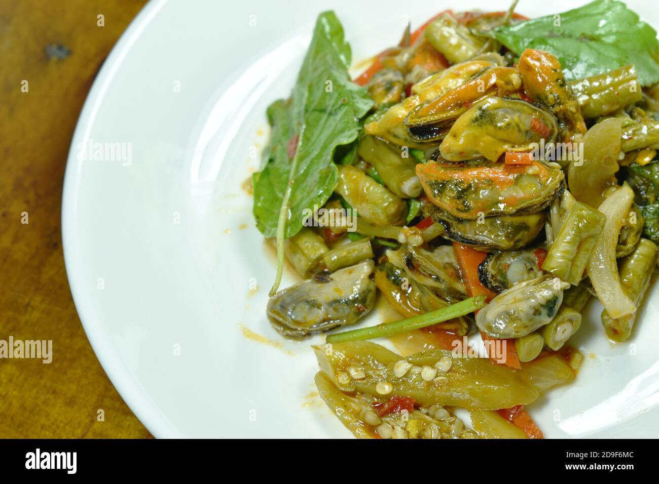 spicy stir fried mussel with basil leaf on plate Stock Photo - Alamy