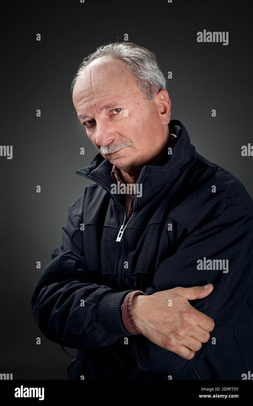 Portrait of a wise old man in a dark jacket Stock Photo - Alamy