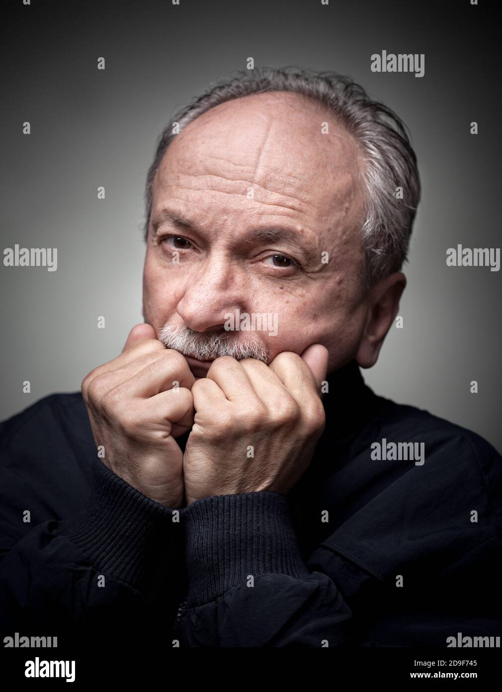 Portrait of senior man prop up the head with his fists Stock Photo - Alamy