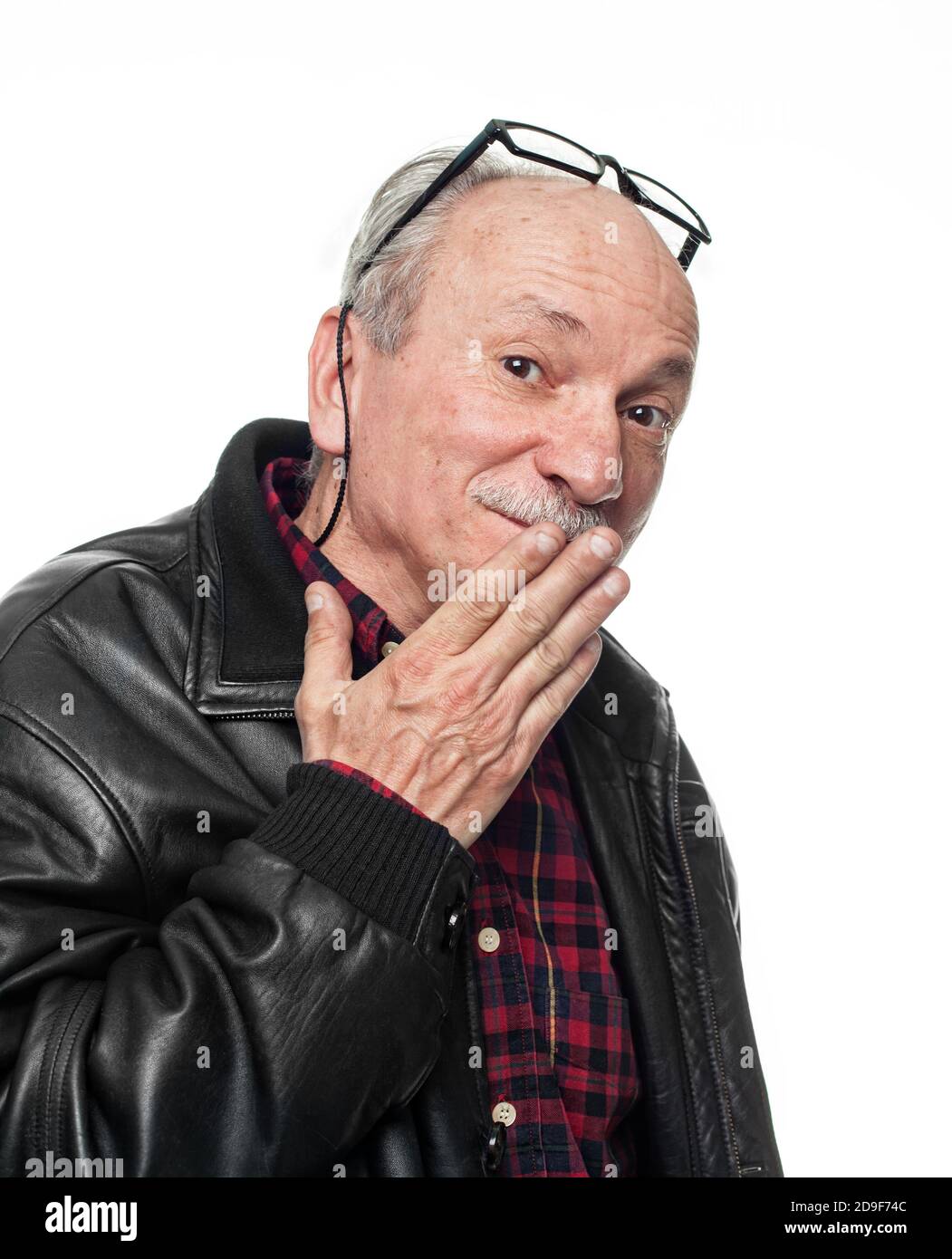 Confused elderly man covers his mouth with his hand Stock Photo - Alamy