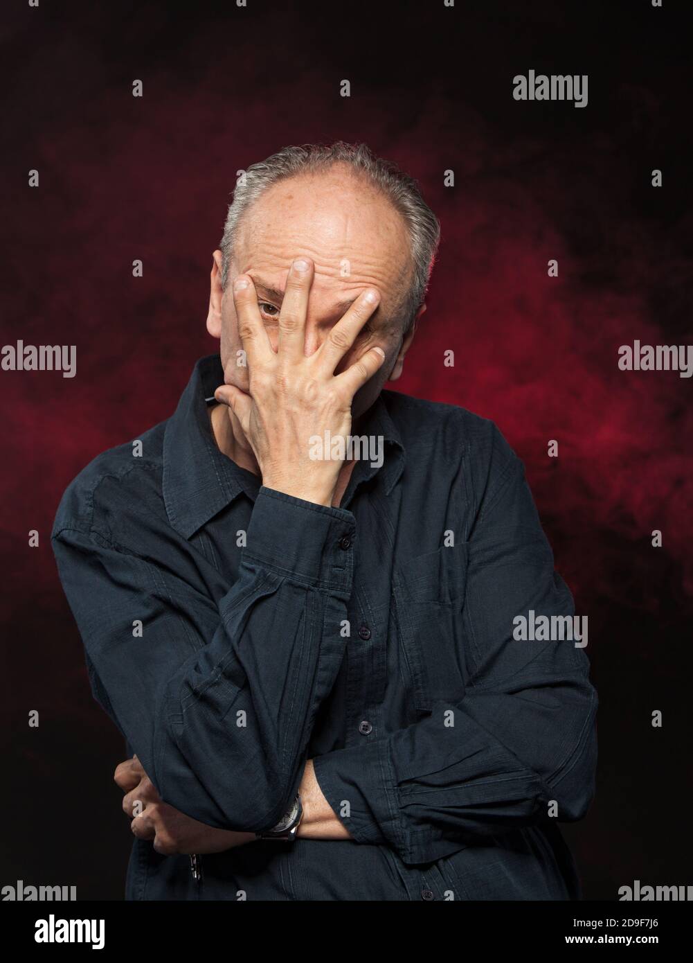 Portrait of an elderly man with face closed by hand Stock Photo - Alamy