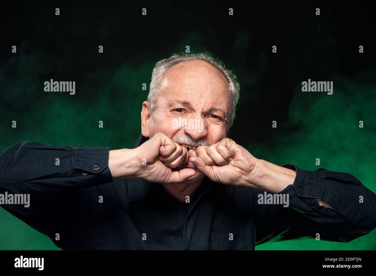 old man biting his hands in despair Stock Photo - Alamy
