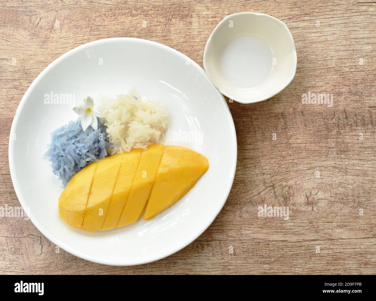ripen mango with white and purple sticky rice dressing coconut milk on ...