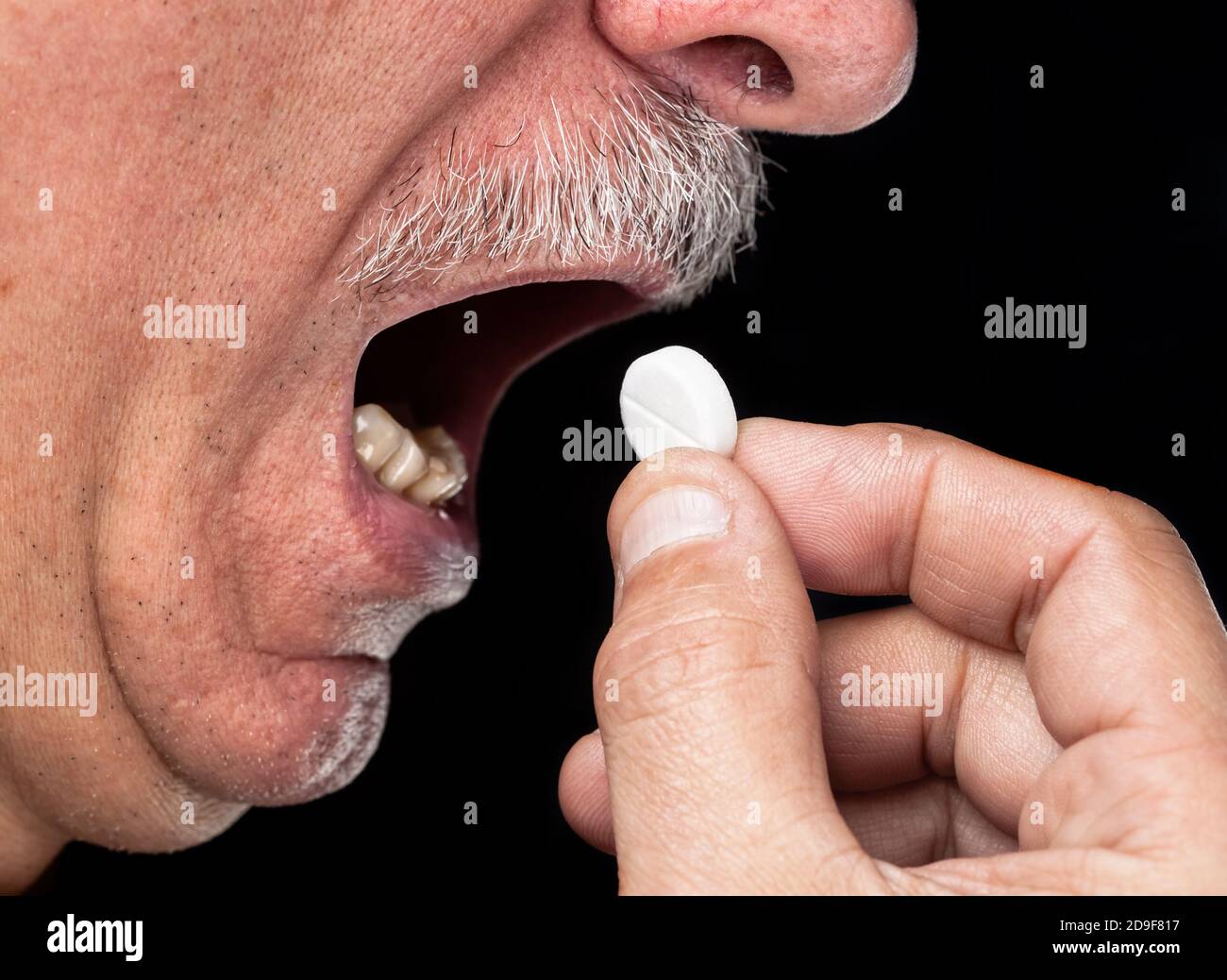 Old man wants to take a pill Stock Photo - Alamy