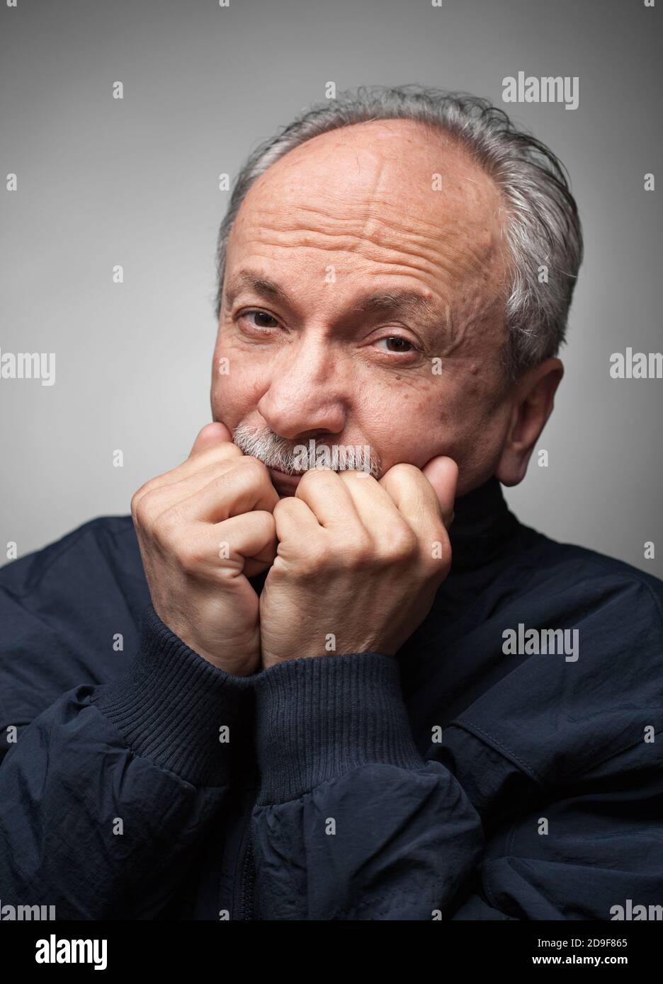 Portrait of senior man prop up the head with his fists Stock Photo - Alamy