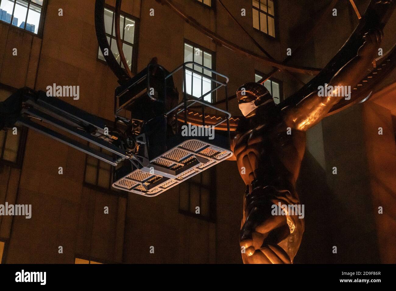 NEW YORK, NY - NOVEMBER 04, 2020: A worker attaches facial mask for the ...