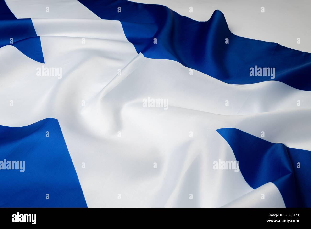 Rippled flag of Scotland lying on white surface Stock Photo - Alamy