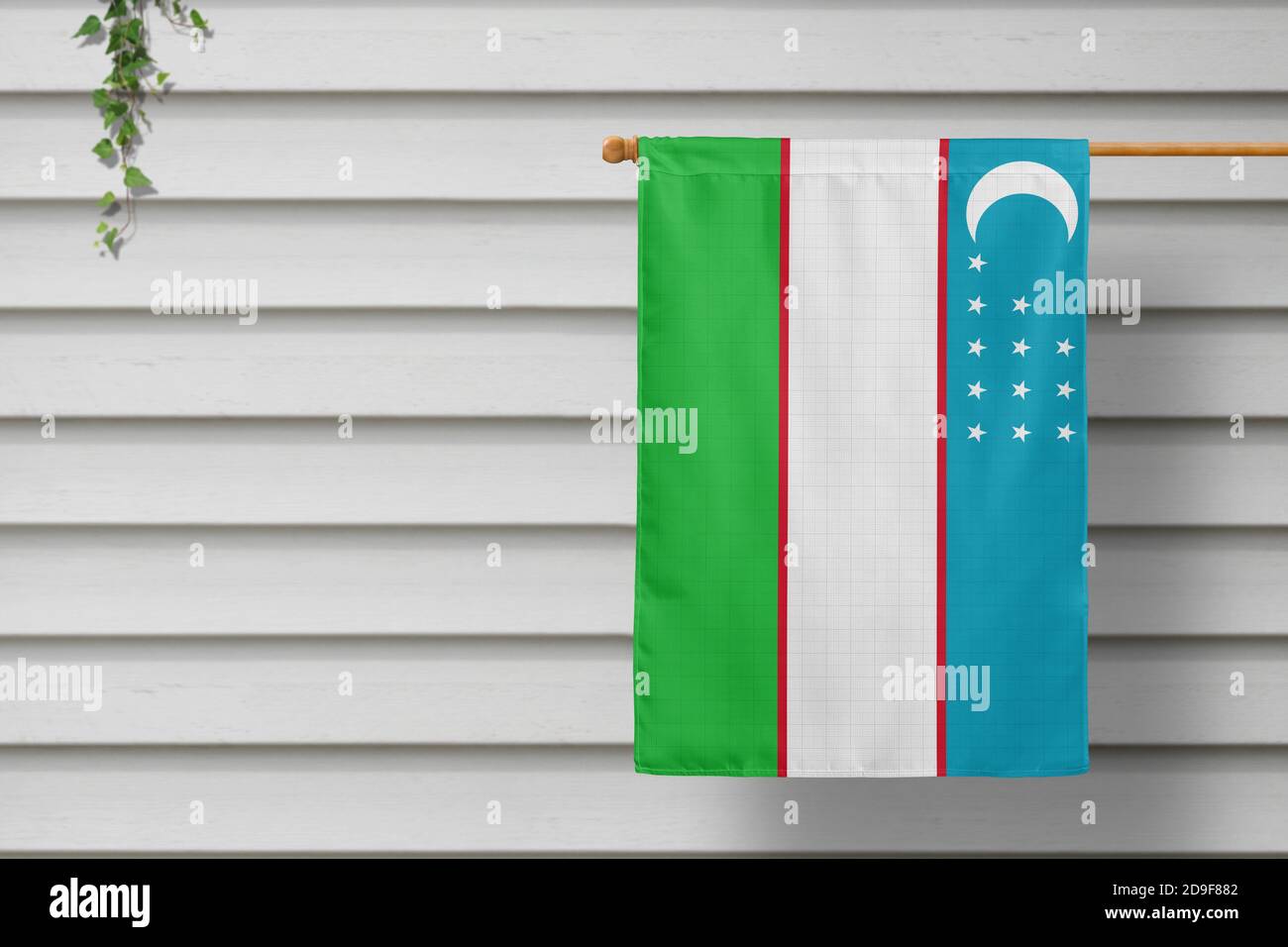 Uzbekistan national small flag hangs from a picket fence along the ...