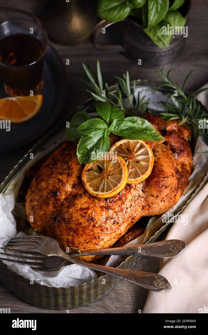 Baked whole chicken in spices with crispy appetizing fried crust in a ...