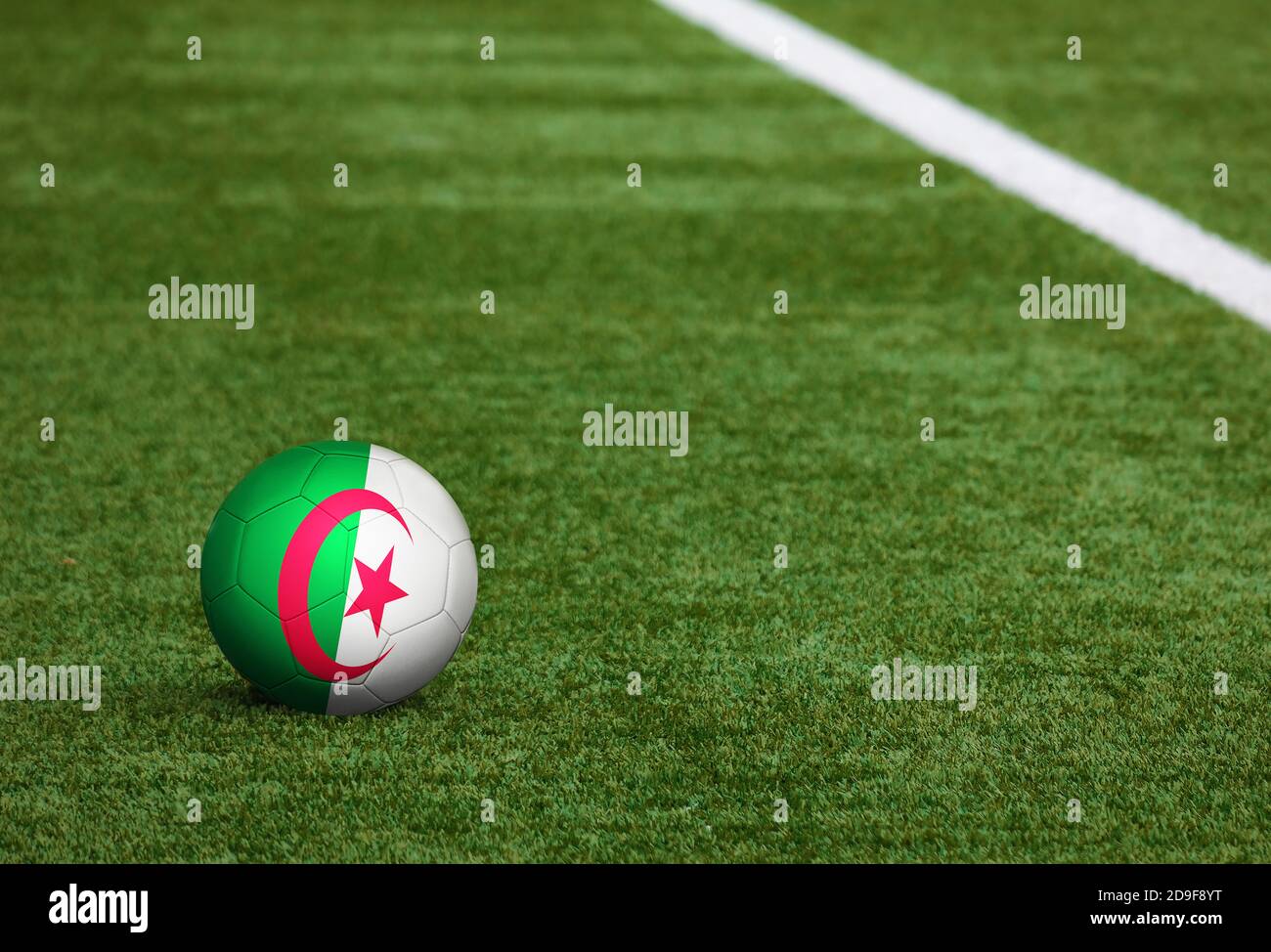 Algeria flag on ball at soccer field background. National football ...