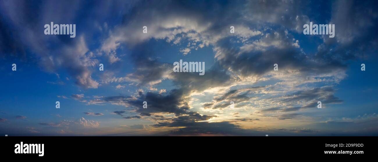 Panorama of dramatic twilight, sunset between clouds on the horizon ...