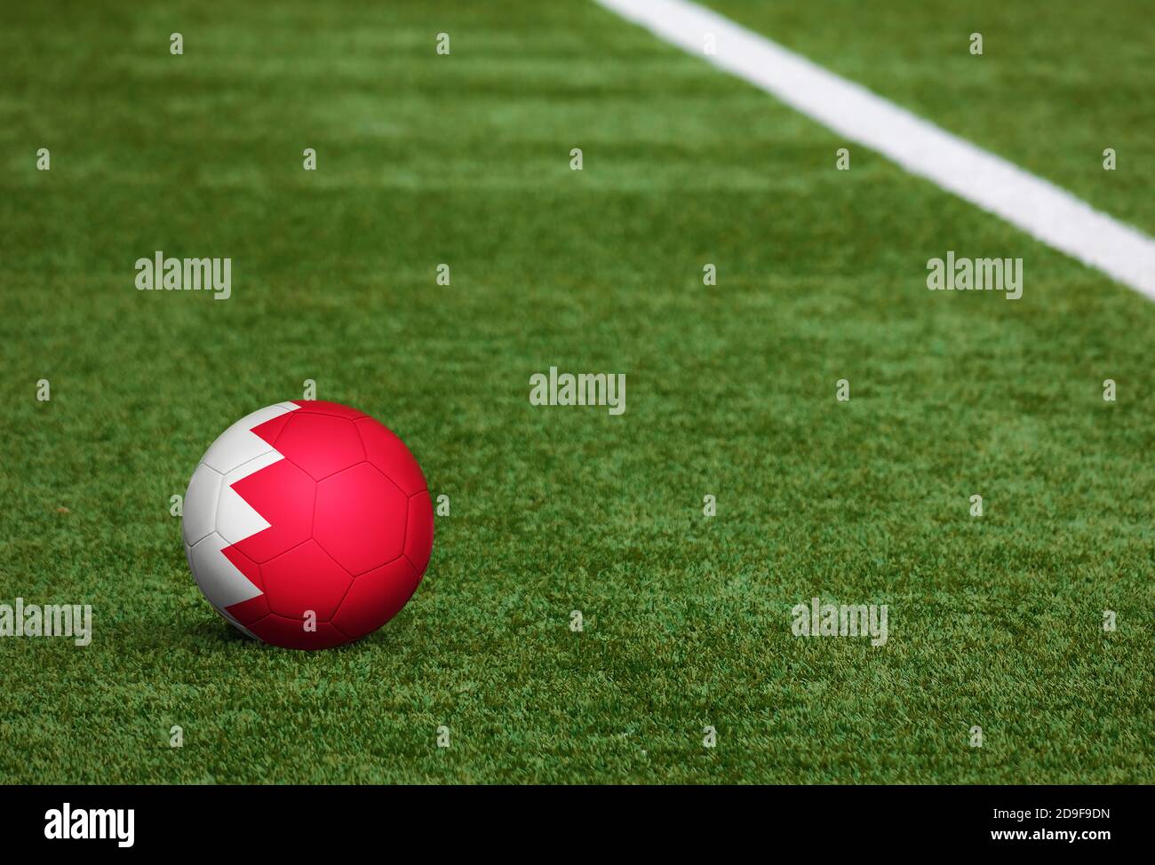 Bahrain flag on ball at soccer field background. National football ...