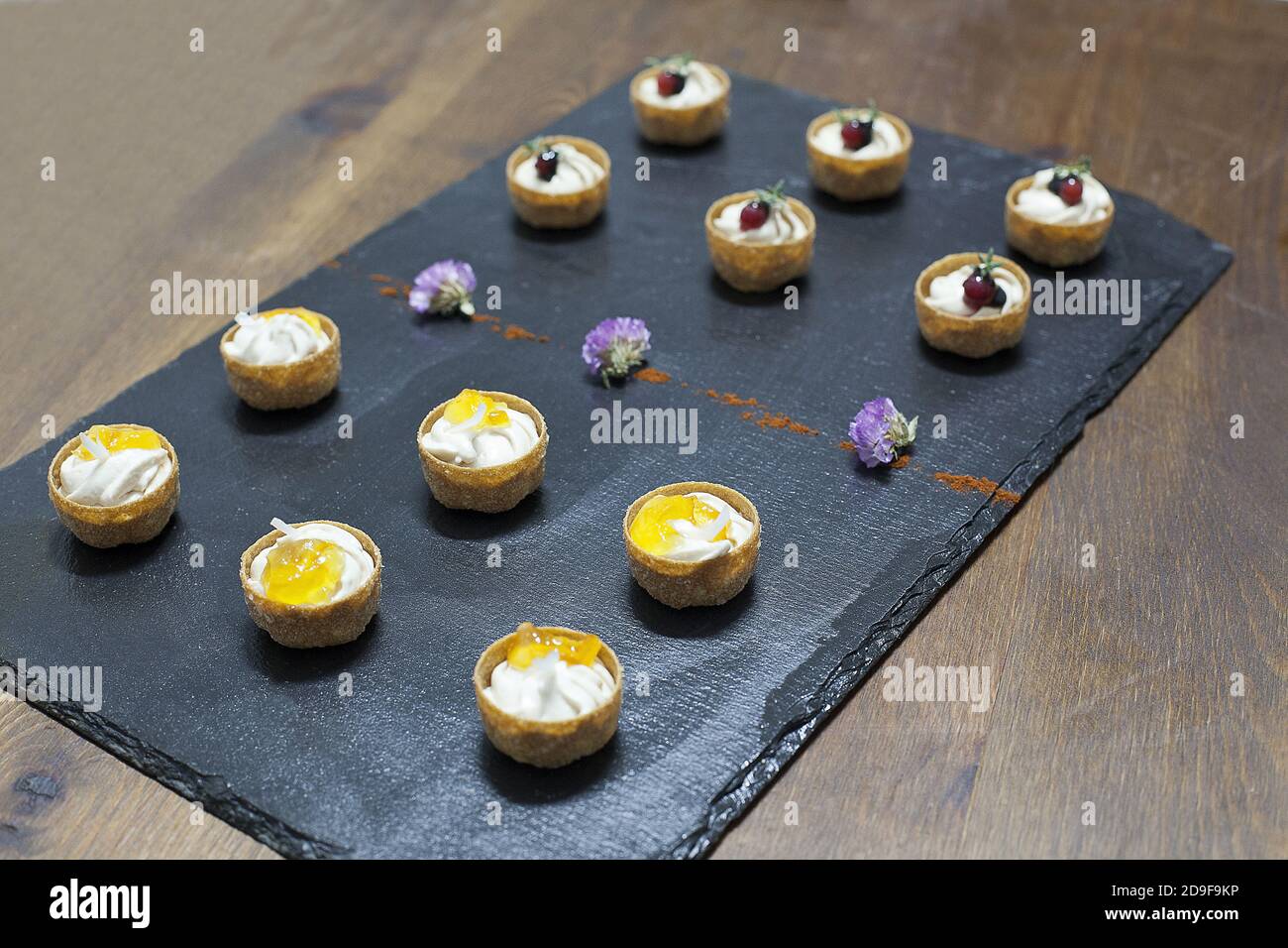 High angle shot of stuffed tarts for the dessert on a board on the ...