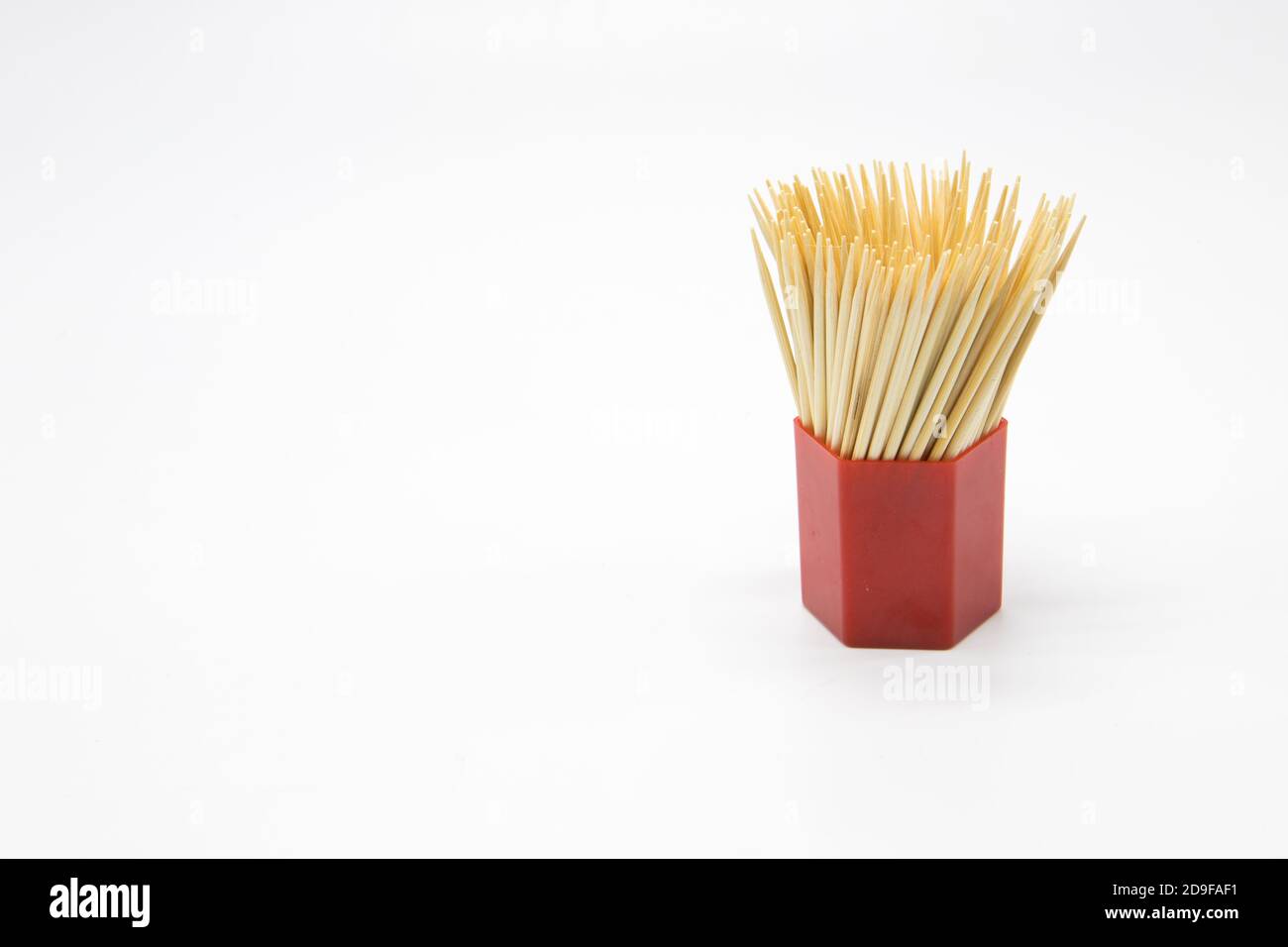 Cocktail sticks in a small red tub on a white background Stock Photo ...