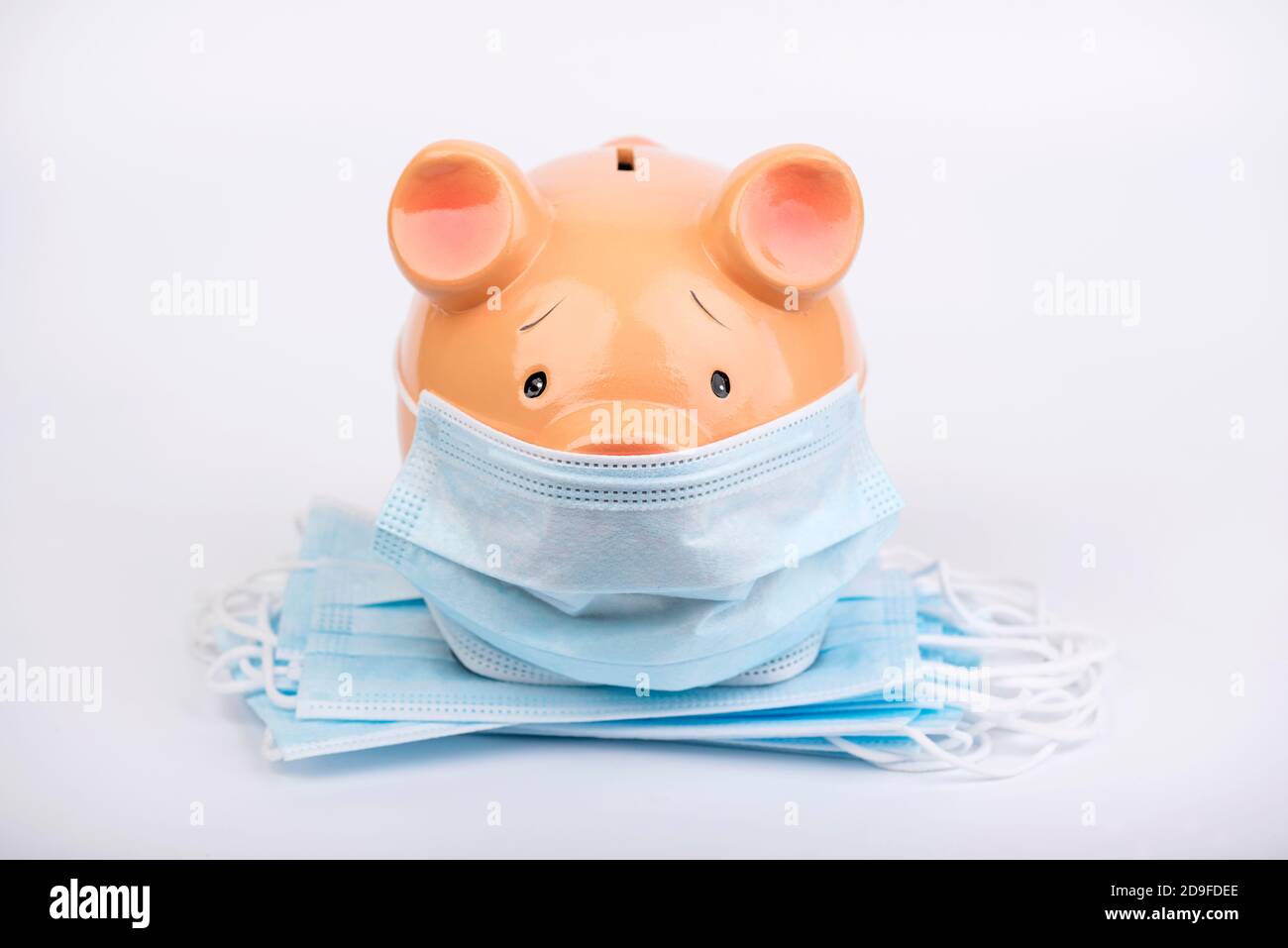 Covid 19 concept. Piggy bank with pile of medical face masks isolated ...