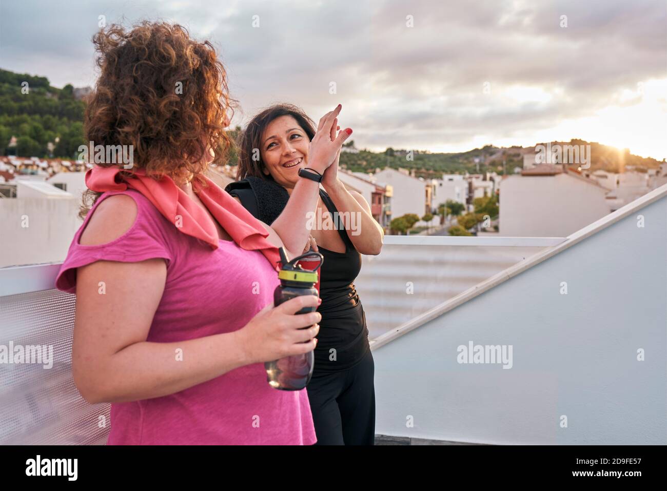 Two women shaking hands after an exercise routine. Concept sport Stock ...