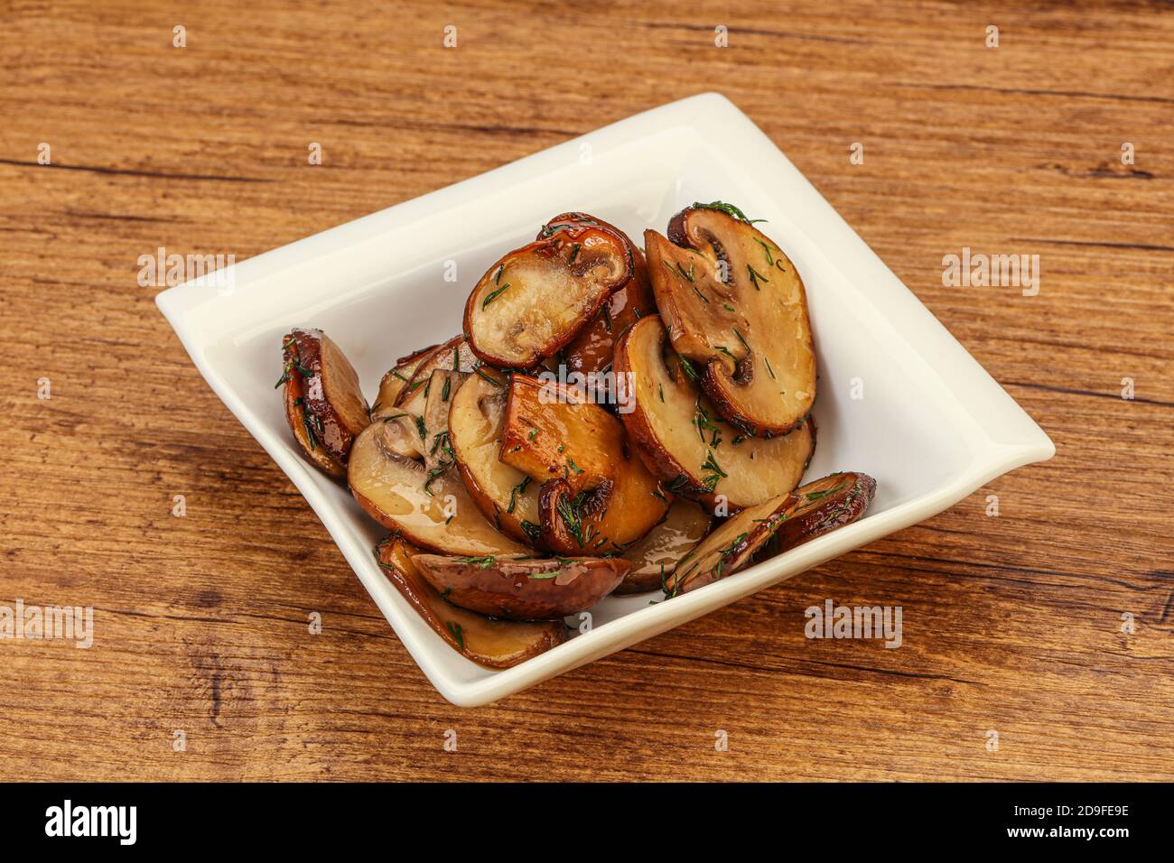 Roasted champignon with herbs and spices in the bowl Stock Photo - Alamy