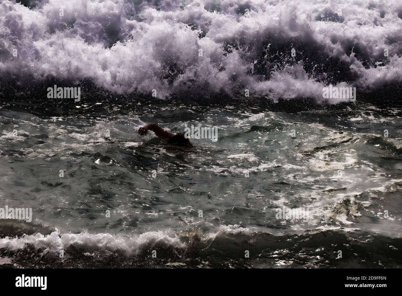 Black anonymous unrecognizable silhouette in a rough sea. Danger storm ...