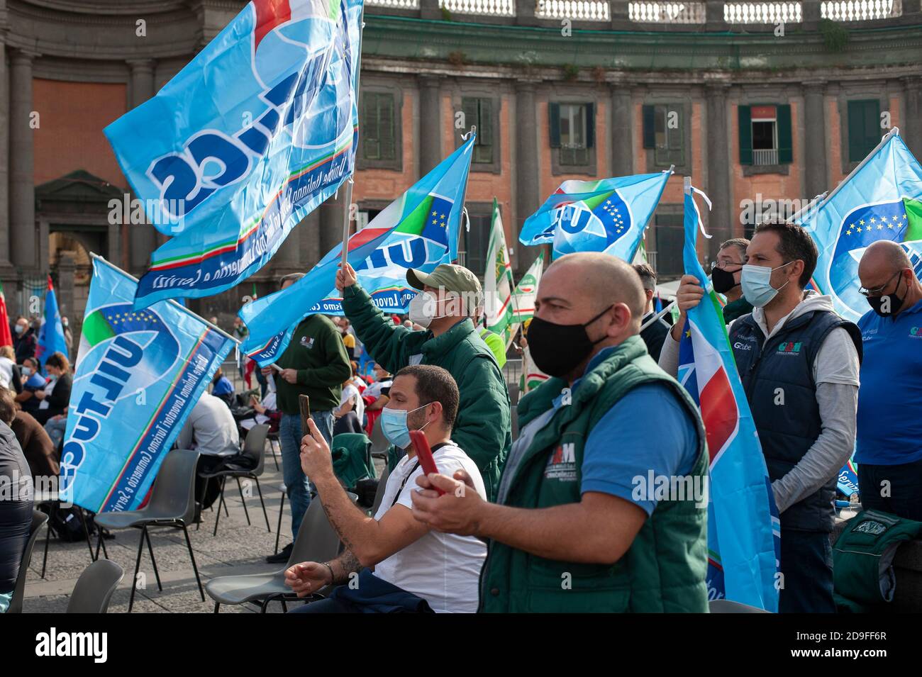 Protesters marching while waving flags during the demonstration.Workers ...