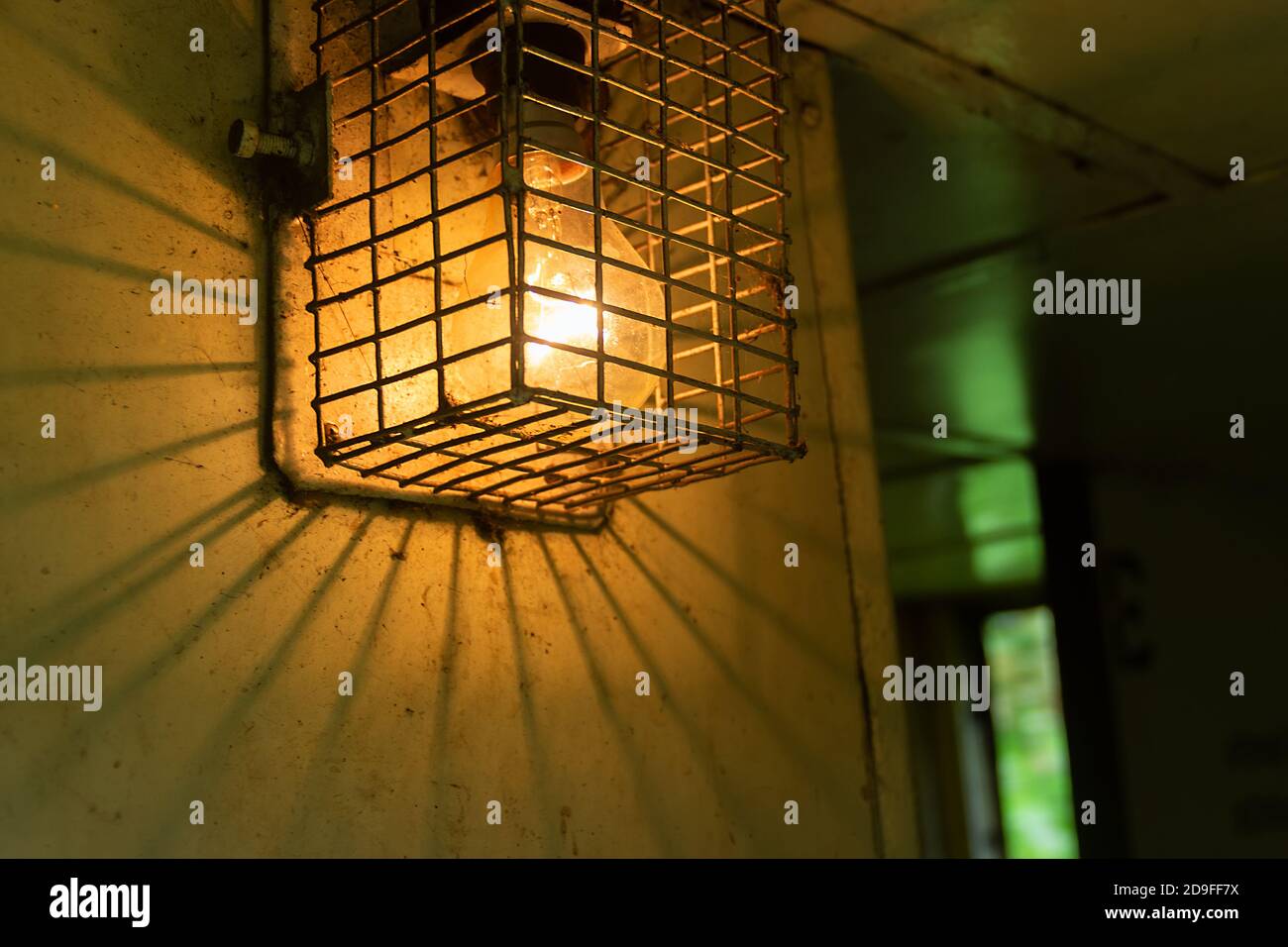 Crate of incandescent lamp in intercity train is covered with cobwebs ...