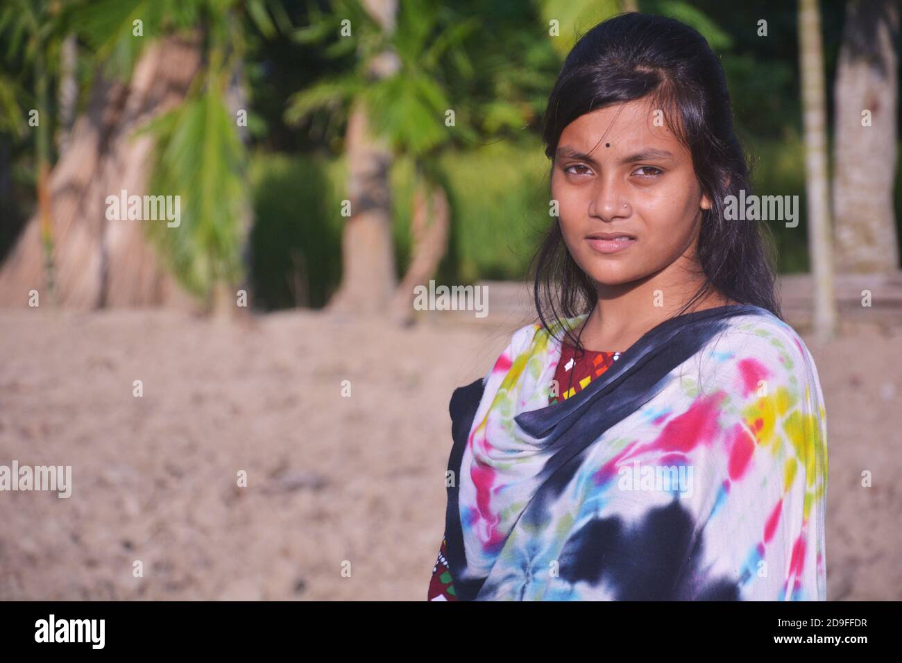 Close up of an Indian Bengali teenage girl with long dark hairs wearing ...