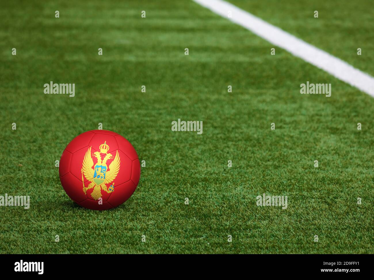 Montenegro flag on ball at soccer field background. National football ...
