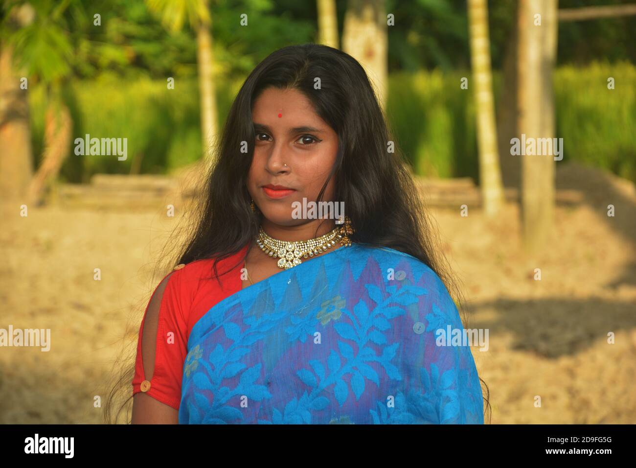 Close Up Of Teenage Indian Bengali Girl Wearing Blue Sari With Long close-up-of-teenage-indian-bengali-girl-wearing-blue-sari-with-long