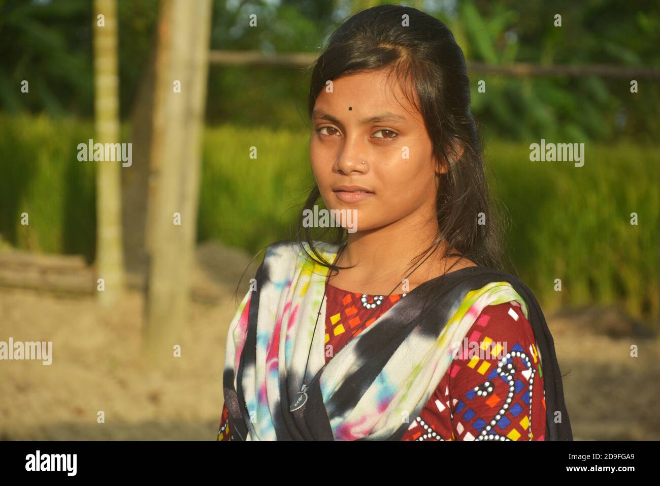 Close up of an Indian Bengali teenage girl with long dark hairs wearing ...
