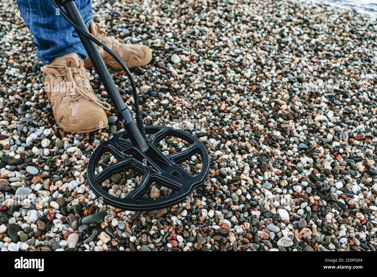 Metal detector coil in action above the ground Stock Photo - Alamy
