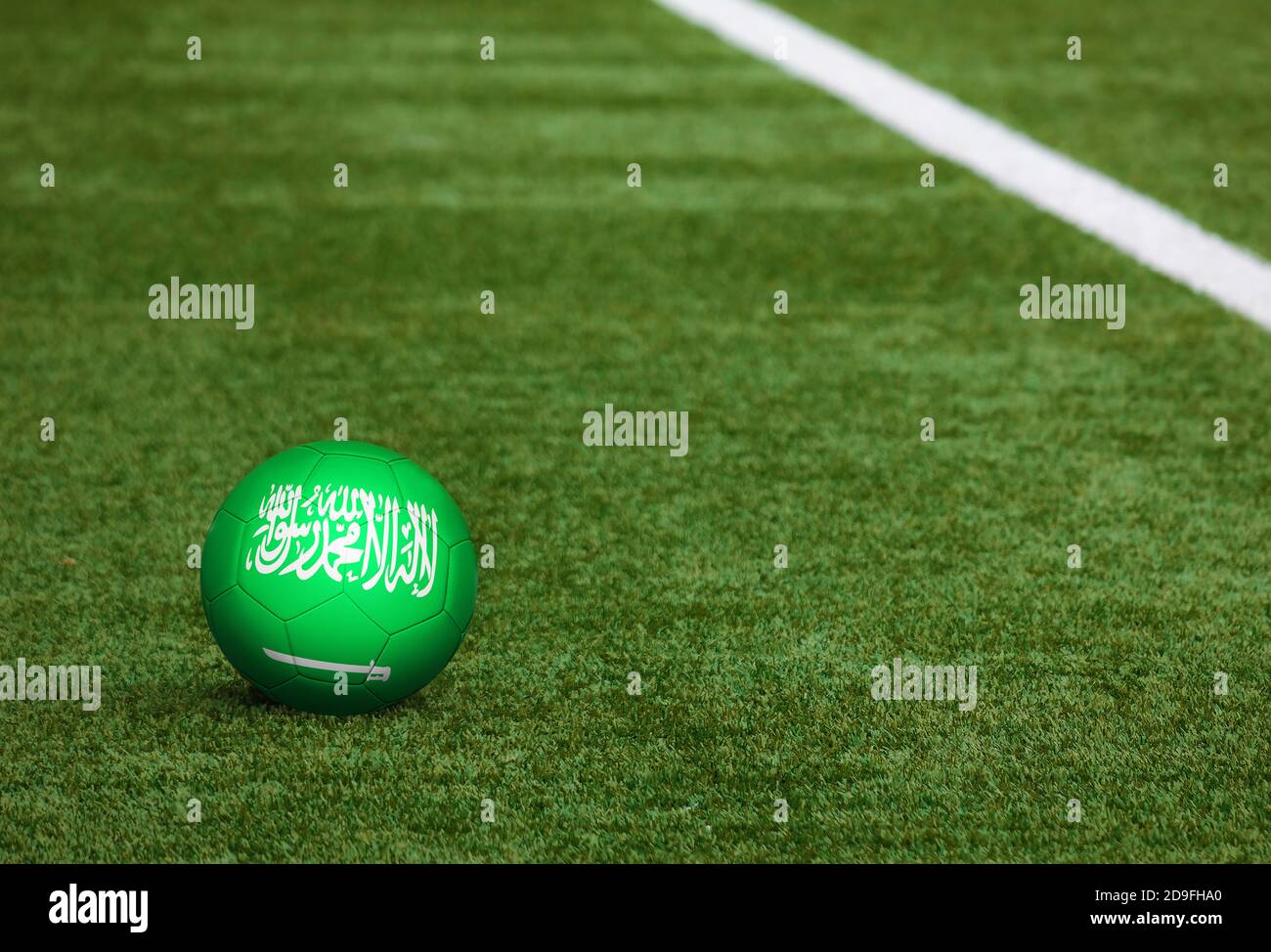 Saudi Arabia flag on ball at soccer field background. National football ...